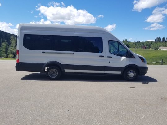 14 pass. Ford Transit Van White side view